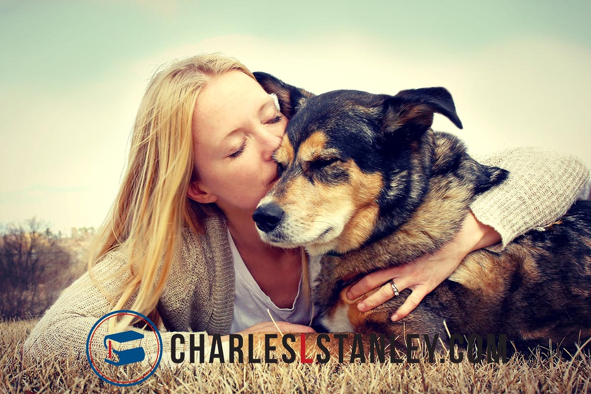 Woman Tenderly Hugging and Kissing Pet Dog | Living Life Successfully